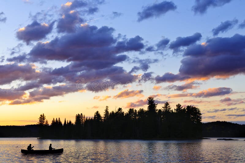 Lake Sunset with Canoe on Beach Stock Photo - Image of peaceful, beach ...