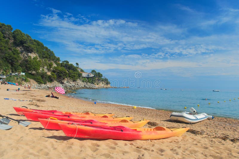 Canoes at the beach stock photo. Image of orange, yellow - 75558754