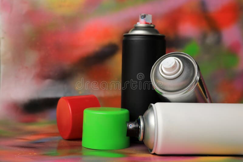 Cans of Different Graffiti Spray Paints on Color Background Stock Photo ...