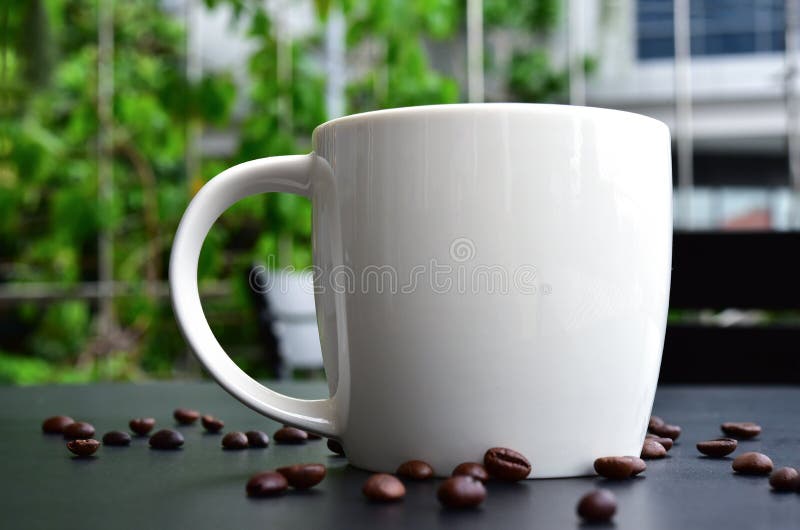 Cap of Coffee on the of Dark Wood Table Have Many Coffee Beans Stock ...