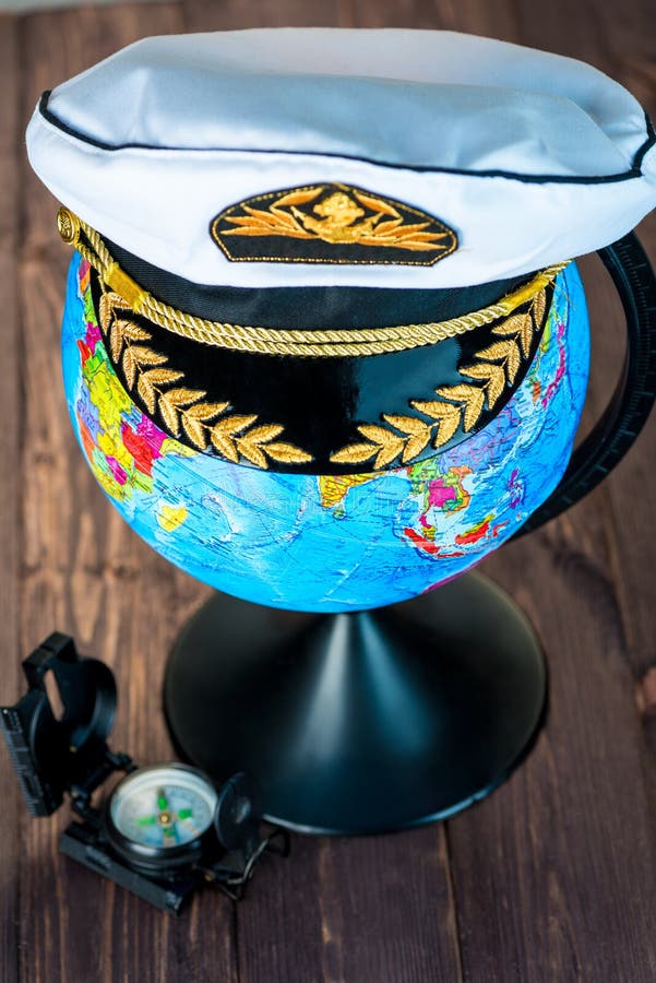 Cap of the Ship`s Captain on the Globe, Next To it Lies a Compass Stock ...
