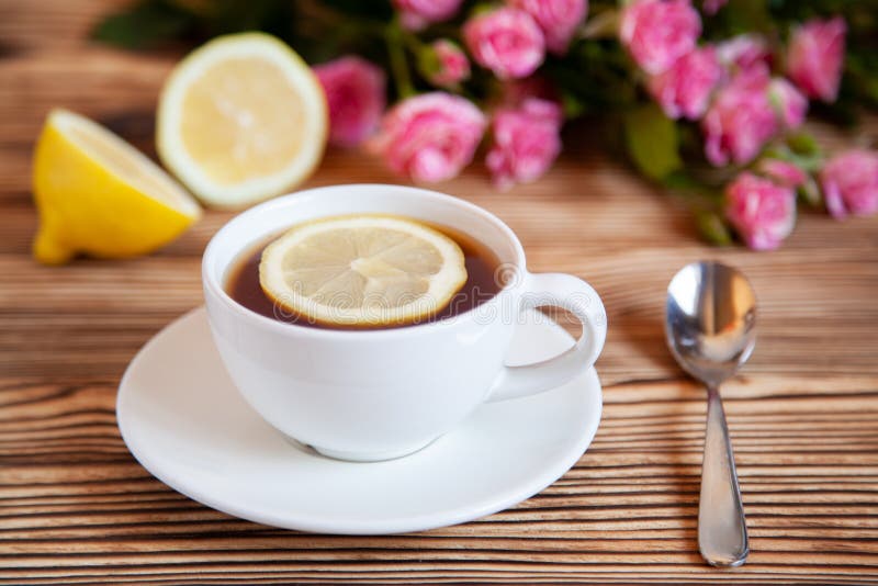 Cap of Tea with Lemon and Flowers on the Wooden Table Stock Photo ...