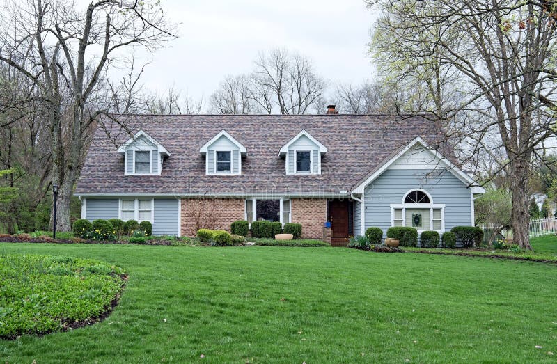 Cape Cod House with Three Dormers & Red Door Stock Photo - Image of ...