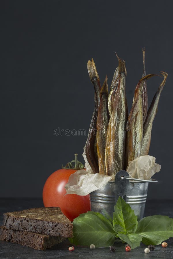 Capelin Cold Smoked Fish in a Decorative Bucket on a Dark Background ...