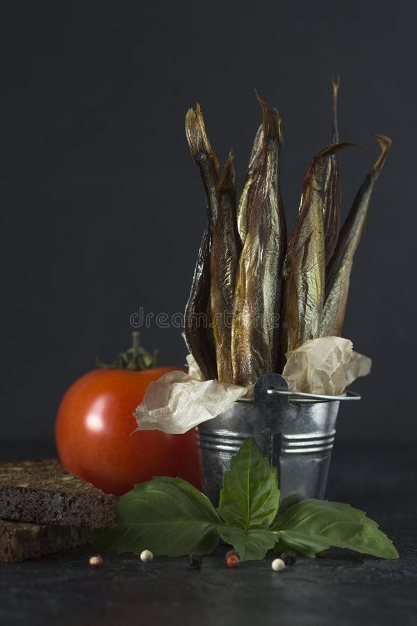 Capelin Cold Smoked Fish in a Decorative Bucket on a Dark Background ...