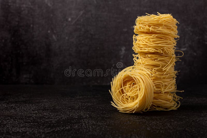 Capellini Spaghetti on a Dark Structural Background with Space To Copy ...