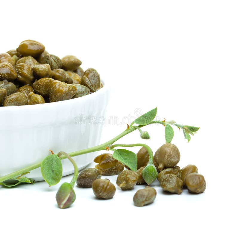 Capers with Green Leaves and Flower in White Bowl Stock Photo - Image ...