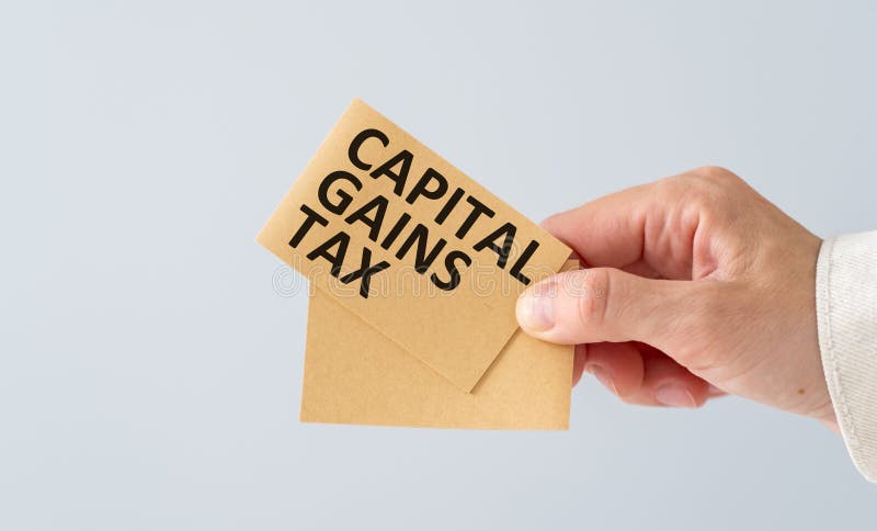 Capital Gains Tax Text on Stickers in Hand on Light Background. Stock ...