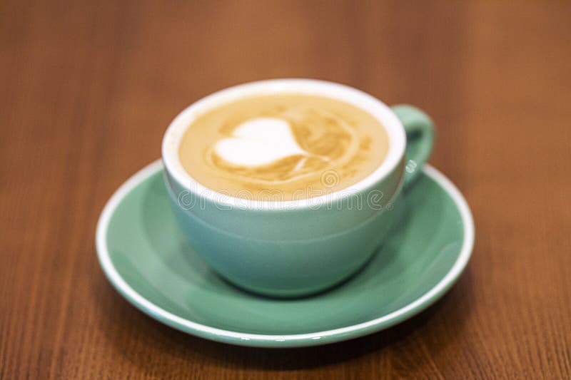 Cappuccino in a Blue Cup with a Heart on the Table. Stock Photo - Image ...