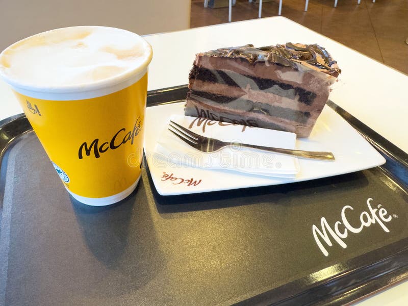 Cappuccino and Chocolate Cake on Mccafe Tray in Coffee Shop Editorial ...