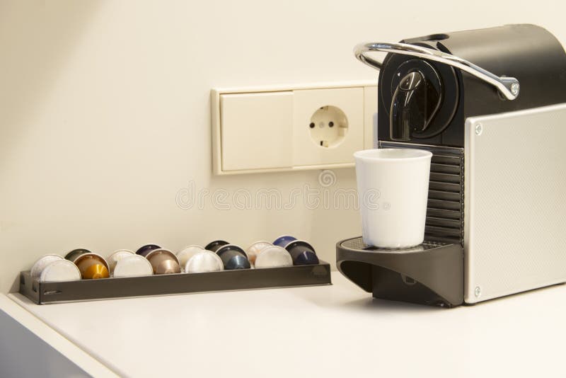 Capsule Coffee Machine on a White Countertop, a Plug and a White Cup ...