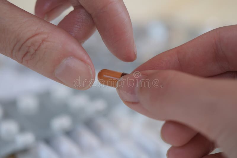 A Capsule Handed Over between Two Hands Stock Photo - Image of tablet ...