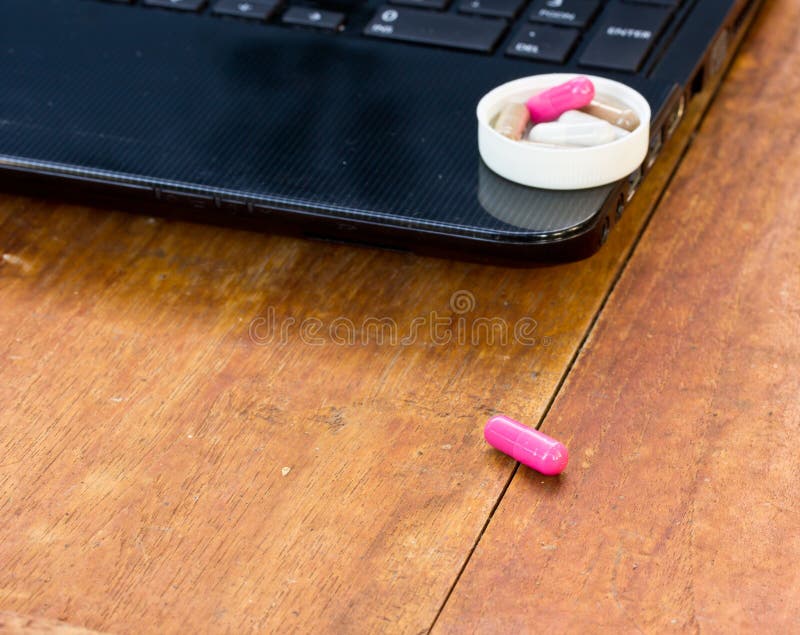 Capsule and Notebooks on Wood Table. Stock Image - Image of computer ...