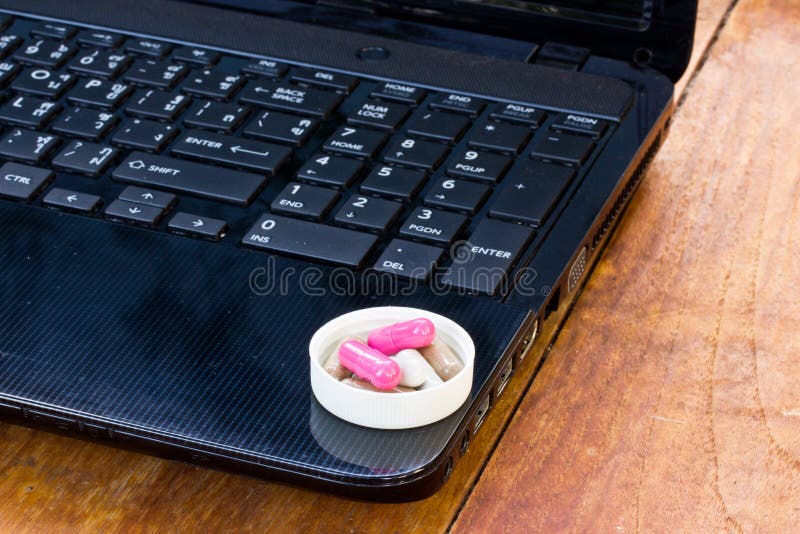 Capsule and Notebooks on Wood Table. Stock Image - Image of office ...