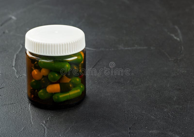 Capsules in a jar stock photo. Image of bottle, clear - 139258570