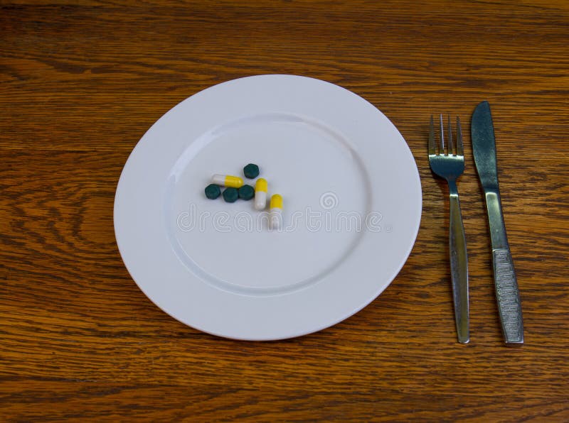 Capsules and Pills on a Plate Stock Photo - Image of lunch, consume ...