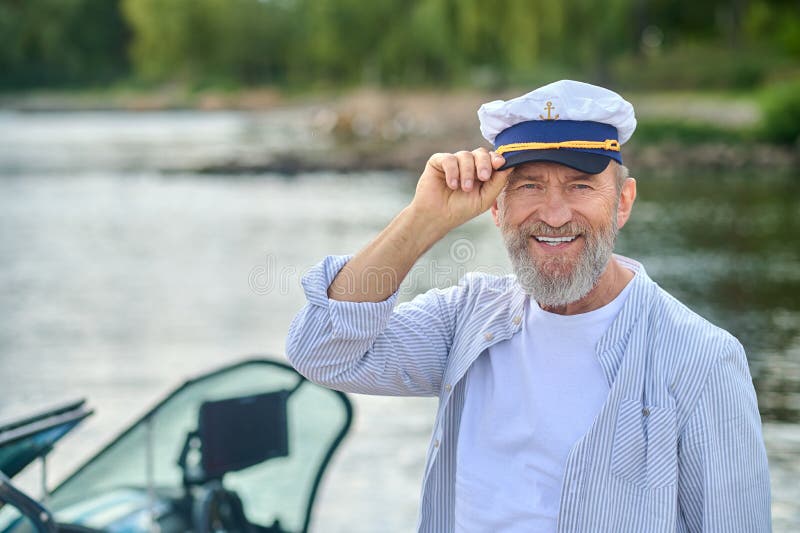 Matture Man in Captains Cap Looking Confident Stock Photo - Image of ...
