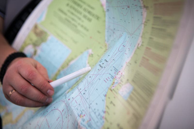 The Captain Shows the Plan of Strait Crossing on the Map Stock Photo ...