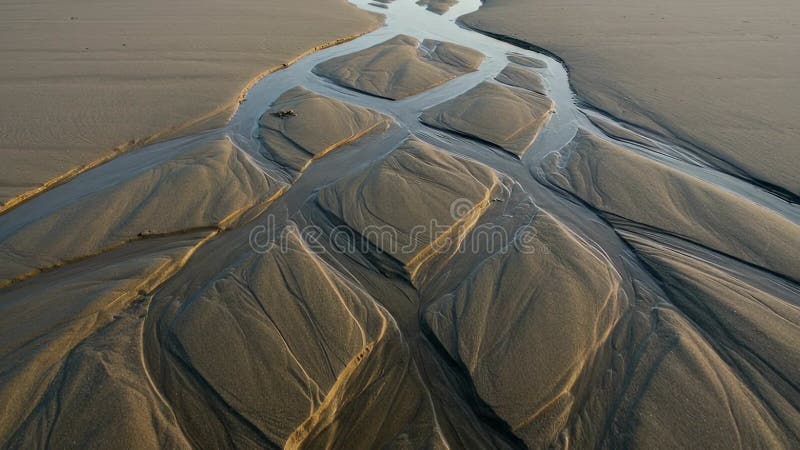 Intricate River Patterns Carved into Sandy Beach at Sunset Stock Video ...