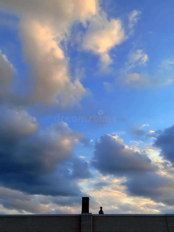 Dramatic Sunset Sky Over Brick Wall with Chimney and Ventilation Pipe ...