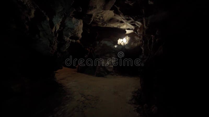 A Captivating and Mesmerizing View of a Dimly Lit Cave Pathway Stock ...