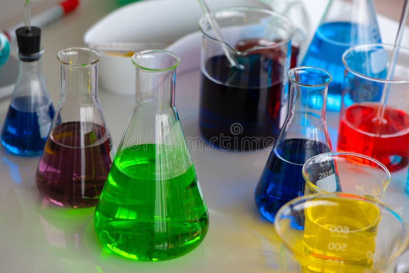 Captivating Scene Unfolded on the White Table As Vibrant Glass Flasks ...