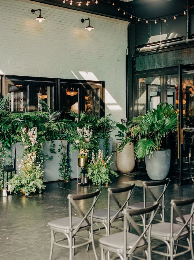 Elegantly Designed Indoor Venue with Greenery and Seating Arrangements ...