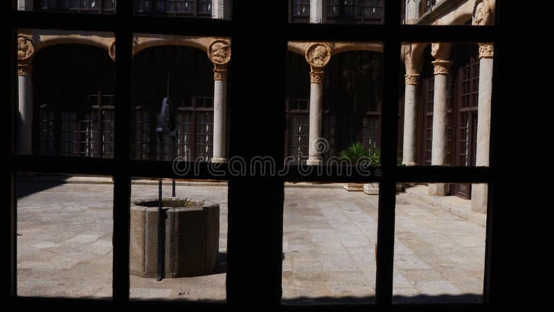 Medieval Courtyard with Ancient Well Seen through Wooden Doors with ...