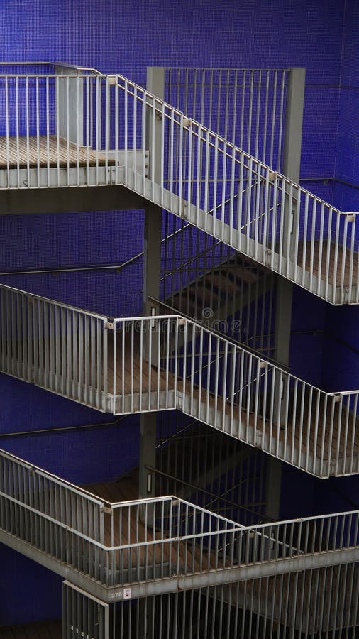 Spiral Stairs Leading To the Street, Symmetrical Blue Wall Effect ...