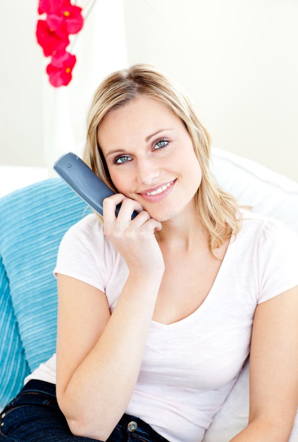 Captivating Woman Smiling and Holding a Remote Stock Image - Image of ...