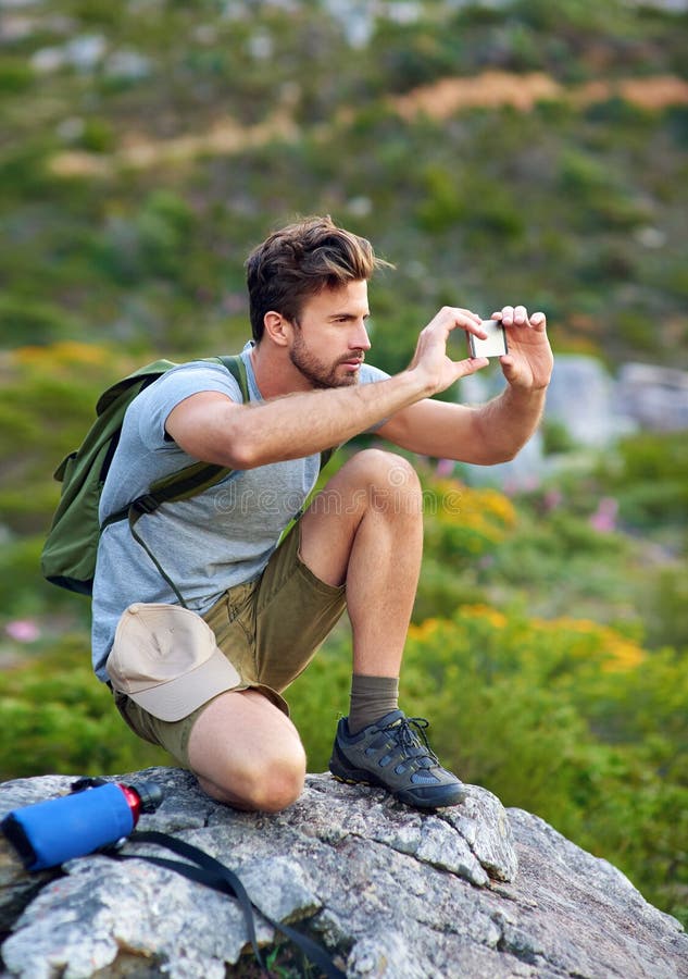 Capturing the View. a Handsome Young Man Snapping Pics while Hiking ...