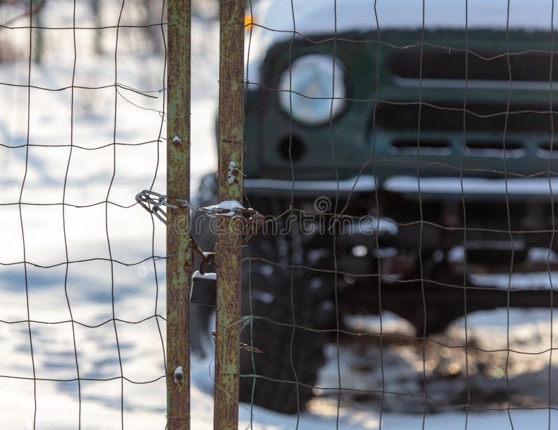 Car behind a metal gate stock photo. Image of steel - 234396400