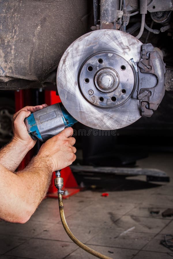 Mechanic Hands on Brakes stock photo. Image of person, maintenance - 648484