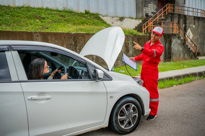 Car Breakdown Assistance a Mechanic is Helping a Driver in Distress ...