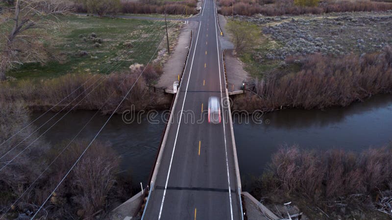 Car on Bridge at Dusk stock photo. Image of dusk, peaks - 145708142
