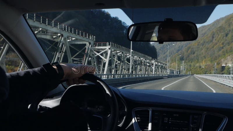 The Car is on the Bridge. Hands on Steering Wheel and Dashboard of a ...