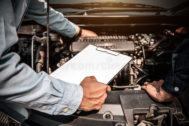 Hand Mechanic Using the Checklist after Change Spare Part Car Engine ...