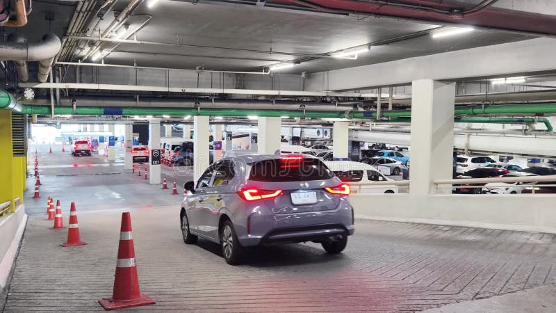 A Car Carefully Navigating through a Parking Area that is Marked with ...