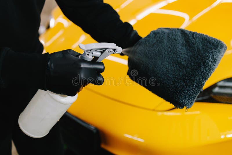 Car Cleaner Spraying Liquid for Waxing on Microfiber Cloth at the ...