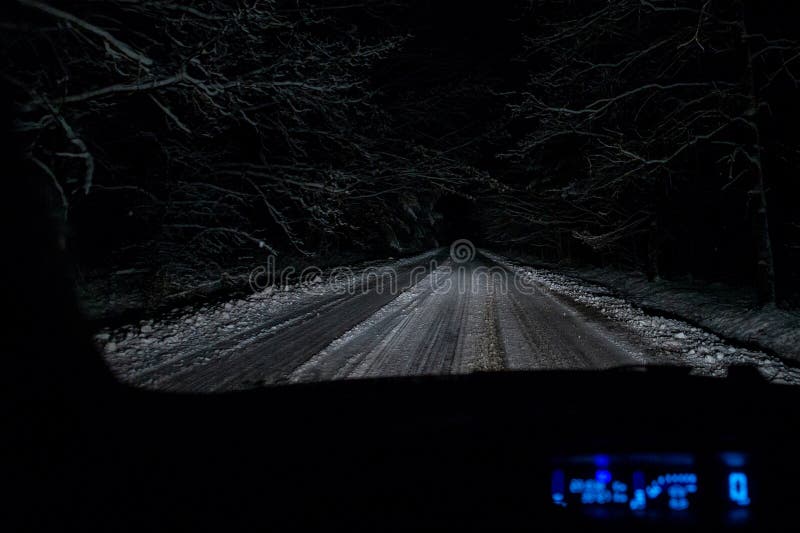Car Cockpit View of Night Car Driving in Winter Forest Stock Photo ...