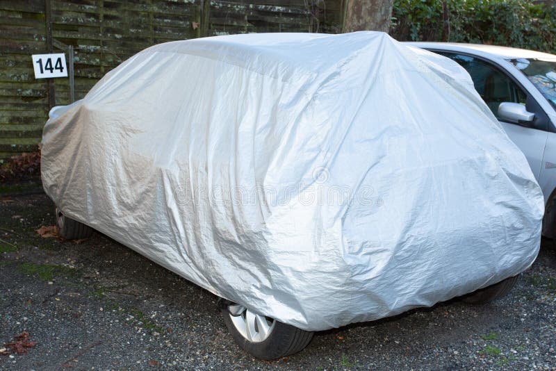 Car Covered with Waterproof Cloth Soft Cover in Street Stock Image ...