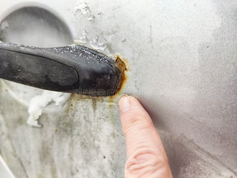 Car Damage Shows Rust Around the Door Handle in a Residential Location ...