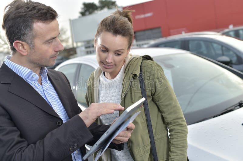 Car Dealer Showing Specs on Tablet Stock Image - Image of showroom ...