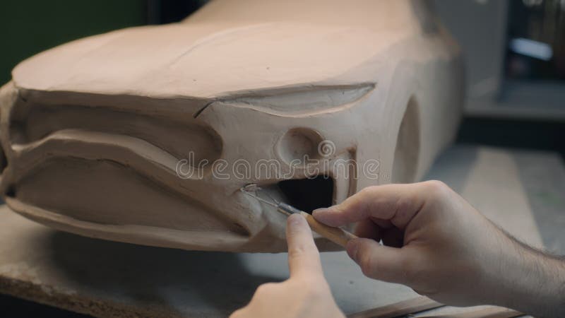 Car Designer Works on Prototype Car Using Shaping Tools To Create ...