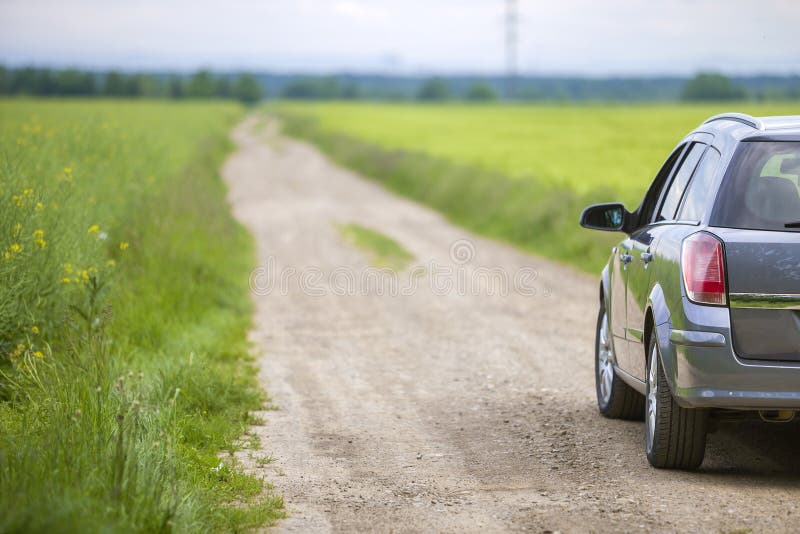 A Car on Dirt Road in Green Field Stock Photo - Image of gravel ...