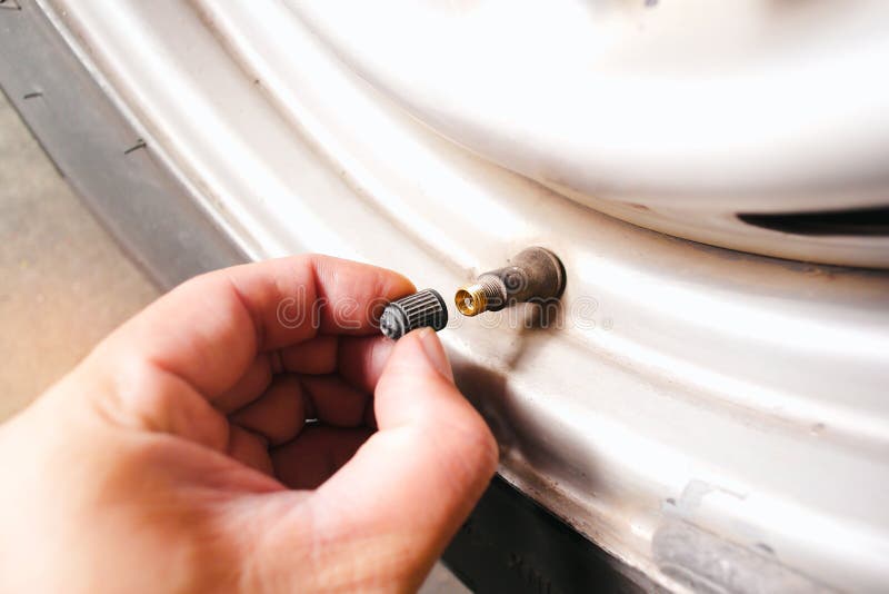The Car Driver Manually Remove the Tire Valve Cap Stock Image - Image ... The Car Driver Manually Remove the Tire Valve Cap Stock Image - Image ...