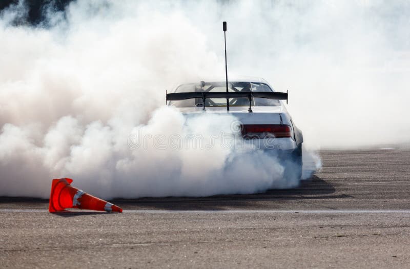 A Car is Driving Down a Road with Smoke Coming Out of the Back Stock ...