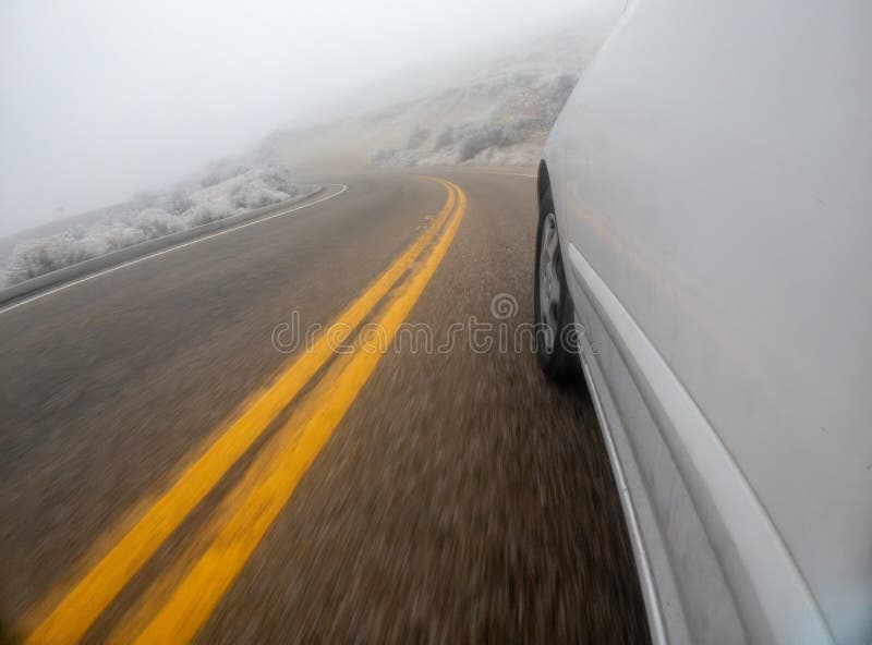 A Car is Driving Down a Road with Yellow Lines Stock Photo - Image of ...