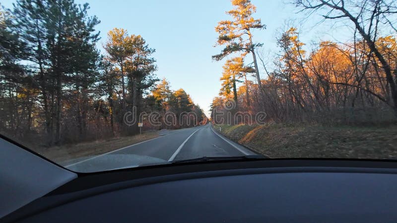 Car Driving on a Fall Seasoned Road at Sunset Stock Video - Video of ...