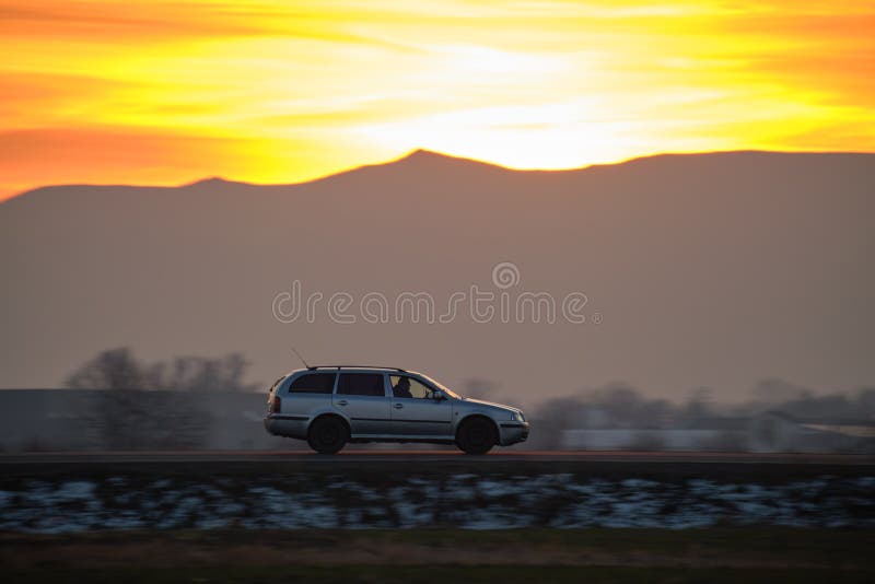 Car Driving Fast on Intercity Road at Sunset. Highway Traffic in ...